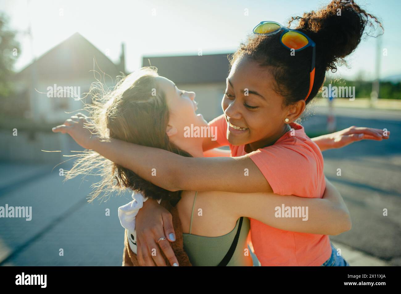 Teenager girl best friends greeting each other, hugging. Girls spending ...