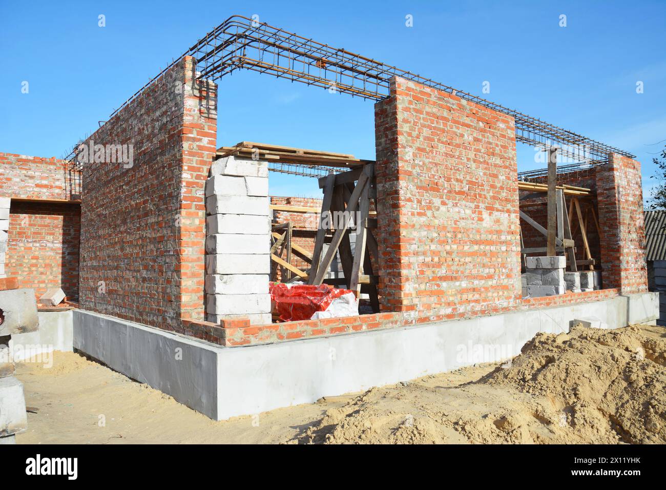 New brick house construction with rebar steel bars, reinforcement ...