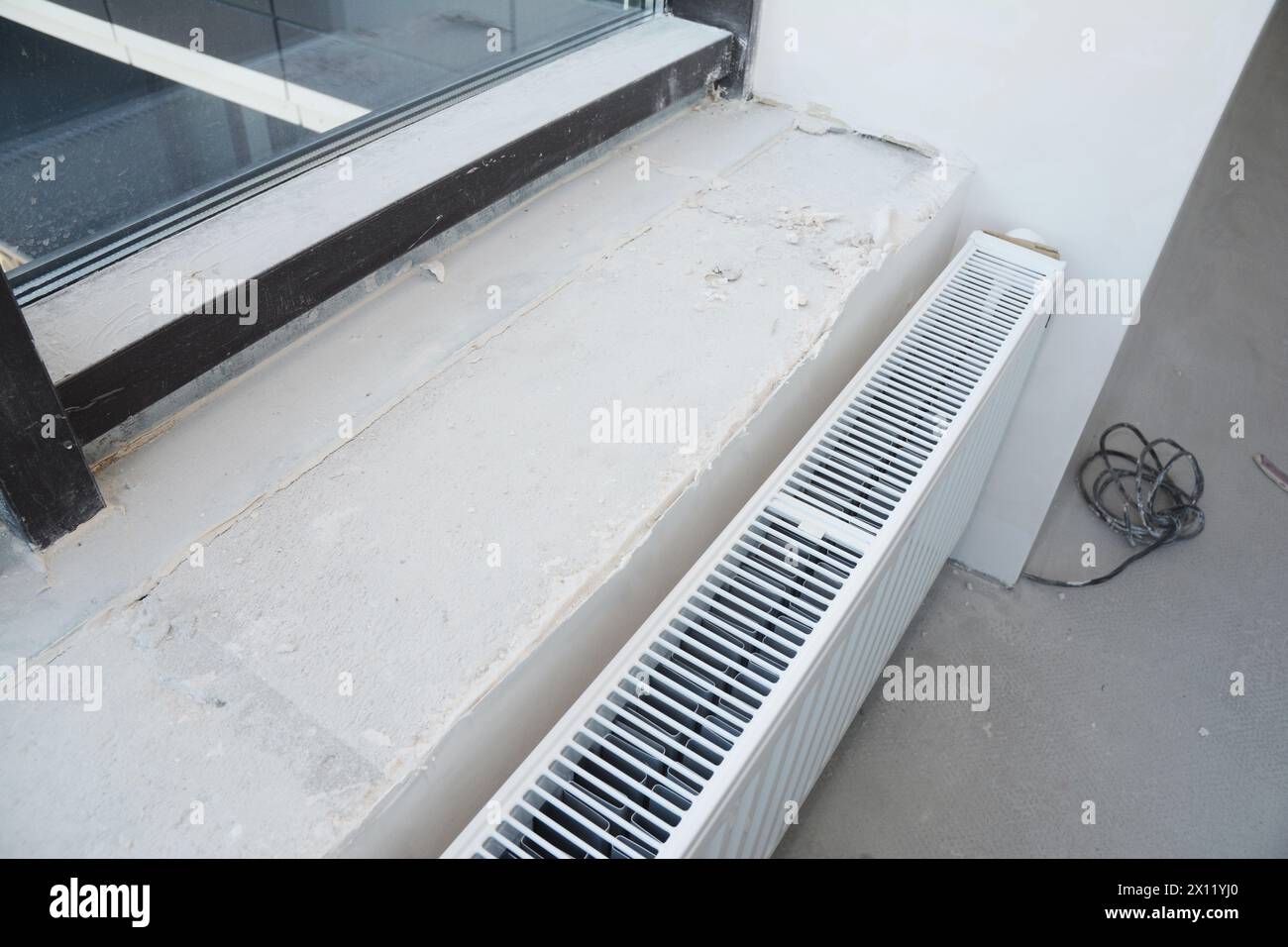 Close up on home radiator heating and unfinished window sill. New ...