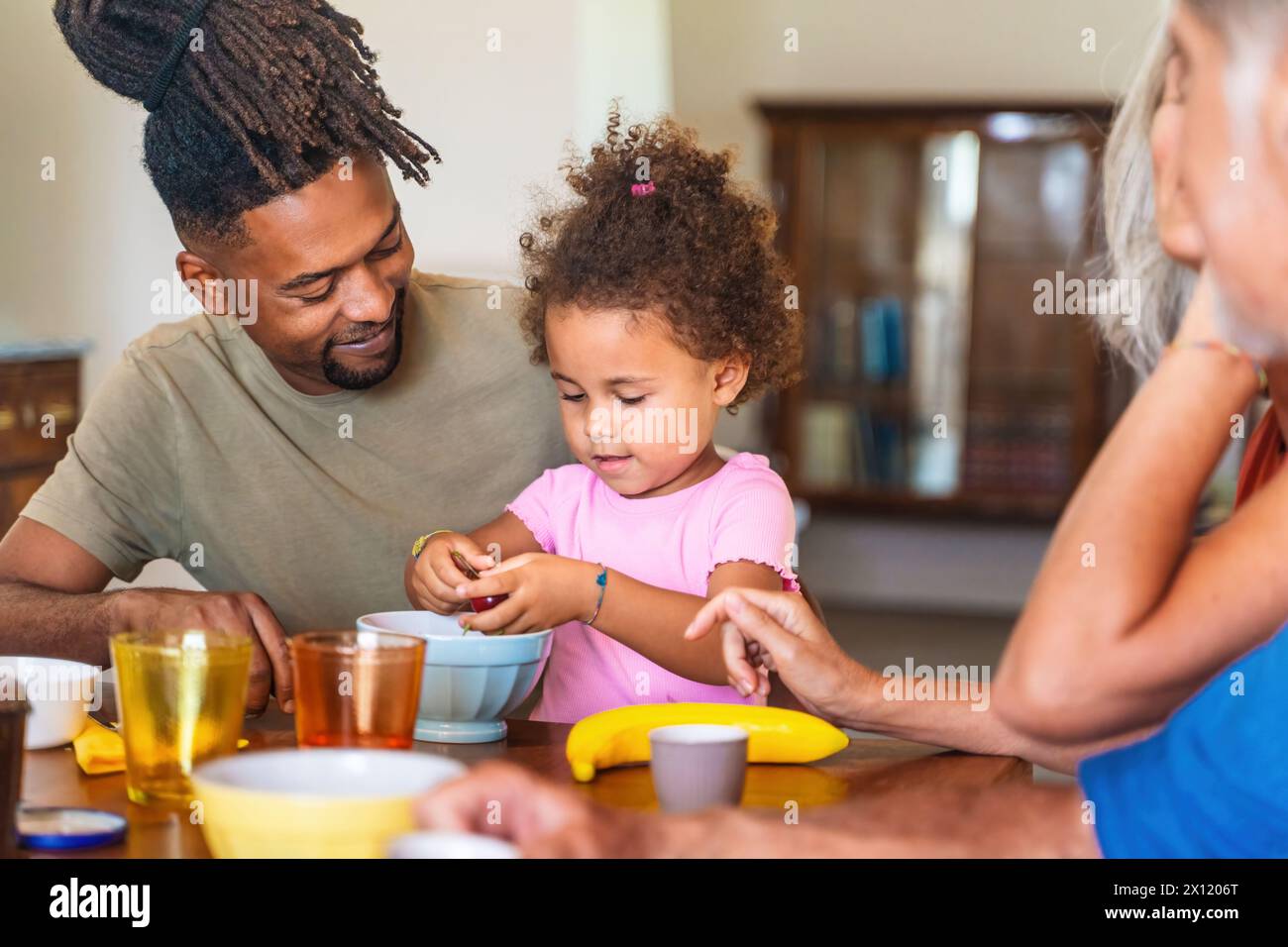 Family gathering in candid moment around the breakfast table – Father ...