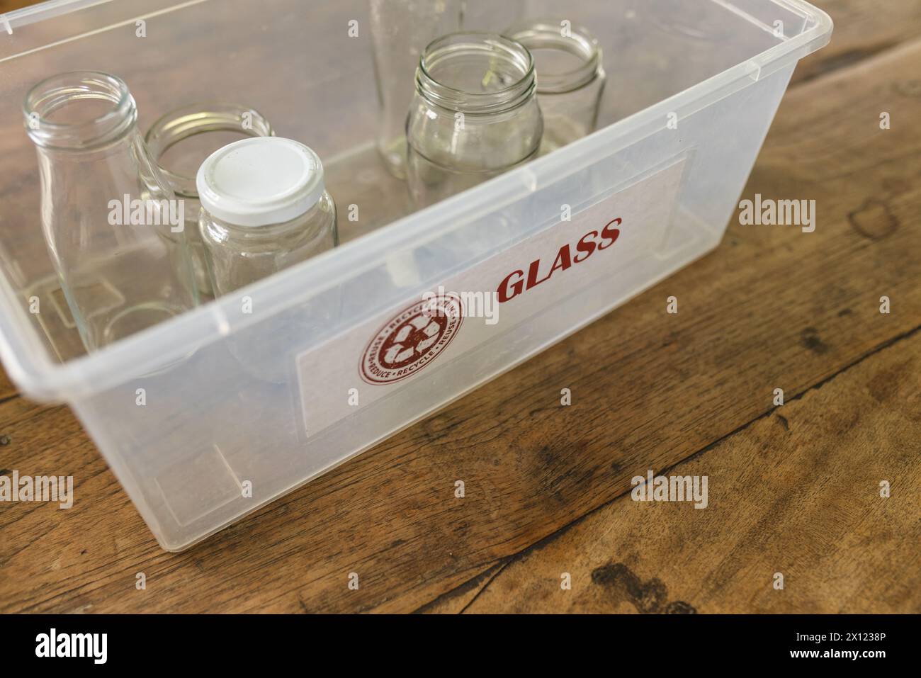 Clear glass jars sitting in labeled recycling bin Stock Photo - Alamy