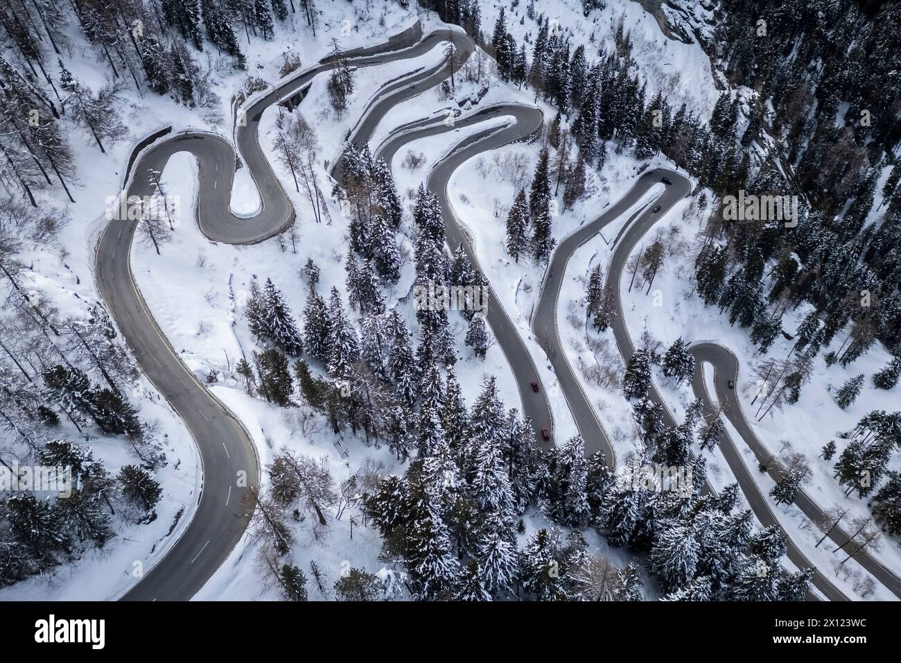Aerial view of the Maloja Pass covered in snow. Maloja, Bregaglia ...