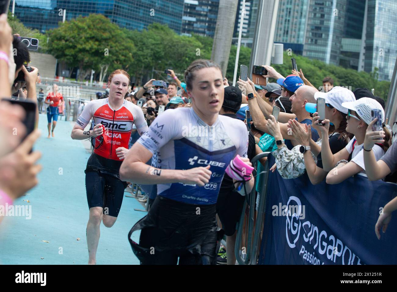 Female triathlon elite athletic came out of the water and are running ...