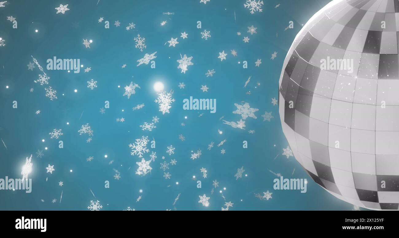 Image of mirror disco ball spinning over snow falling on blue ...