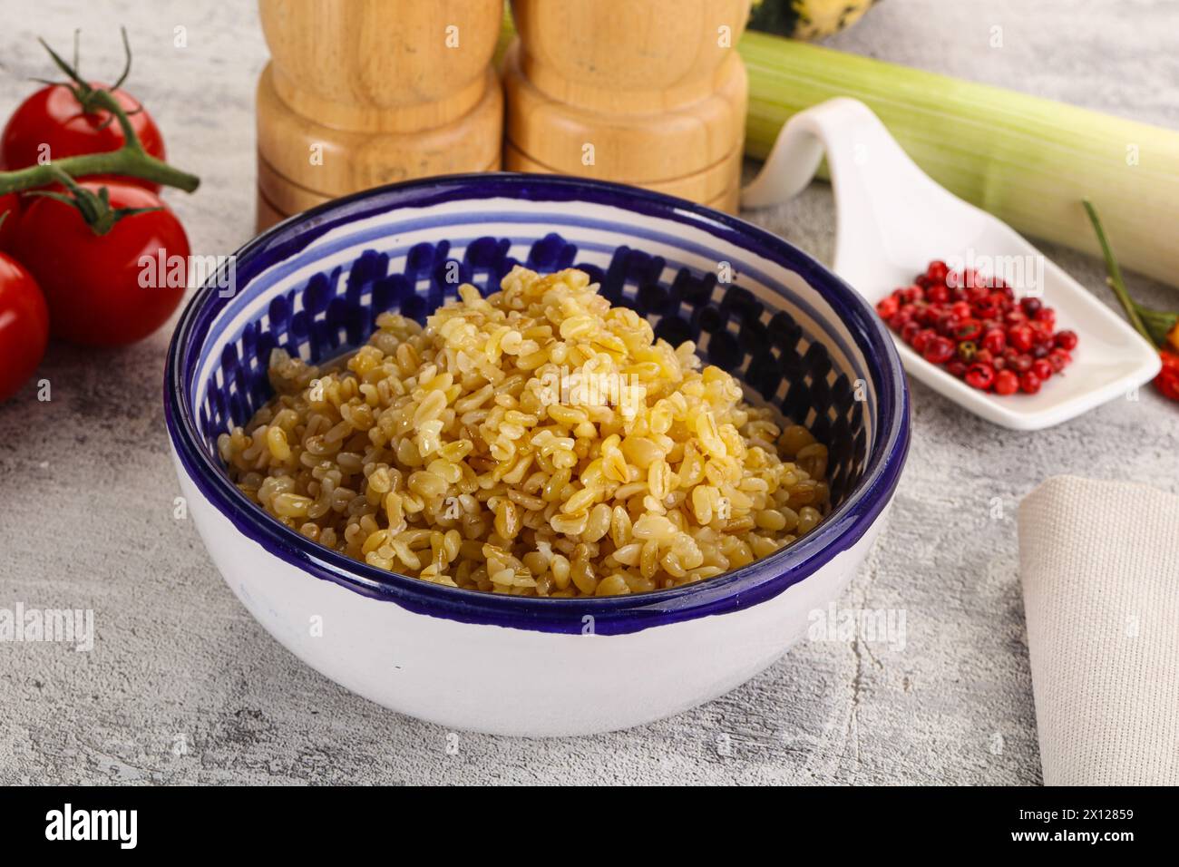 Boiled bulgur wheat in the bowl garnish Stock Photo - Alamy