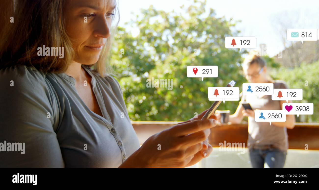 Image of notification bars over caucasian woman scrolling on smartphone at home. Digital ...