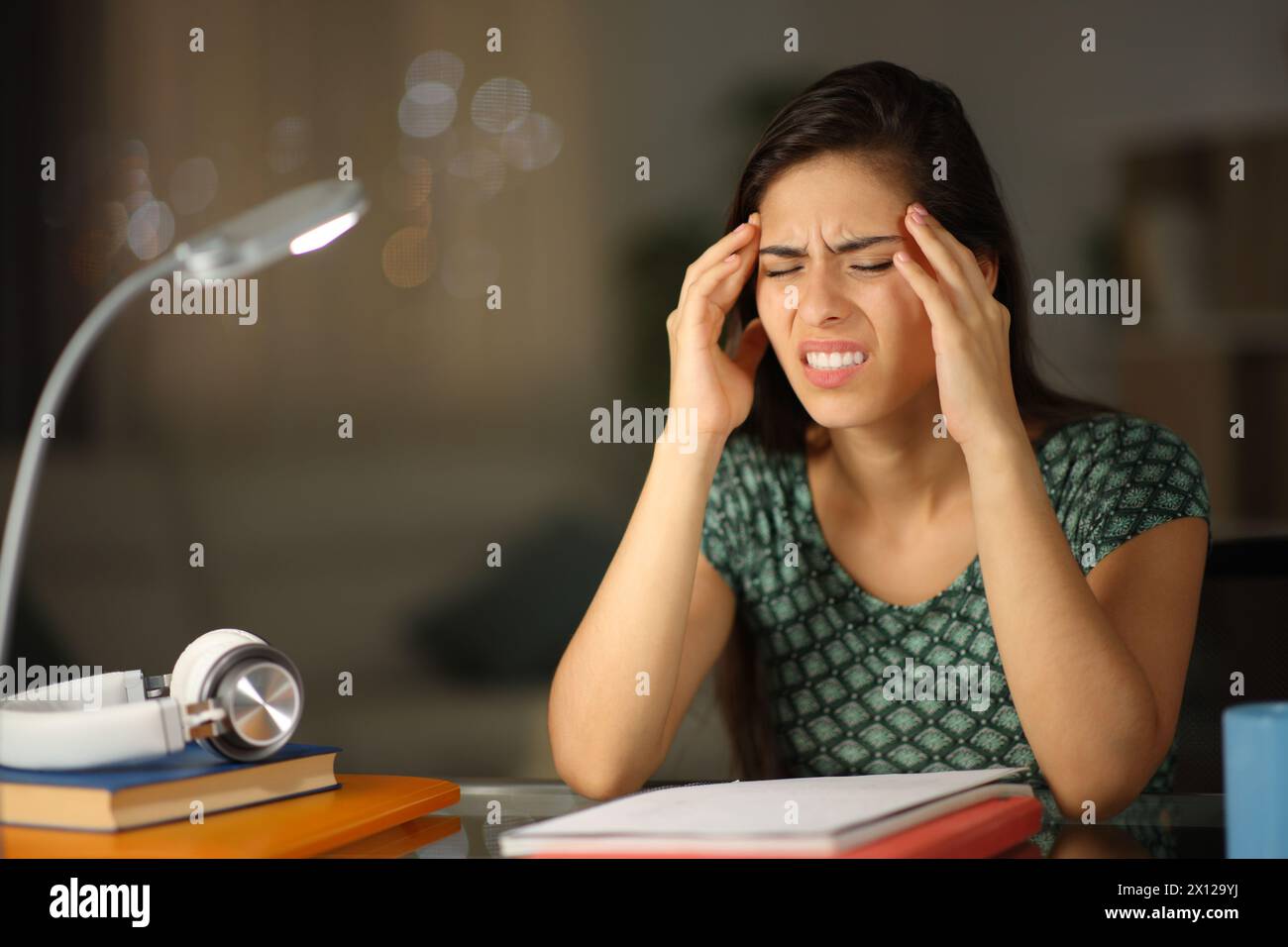 Stressed student suffering head ache in the night at home Stock Photo ...
