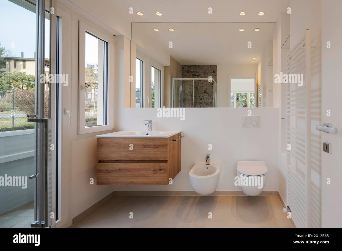 Interior of a modern bathroom. Front view. Aligned the sink the toilet ...