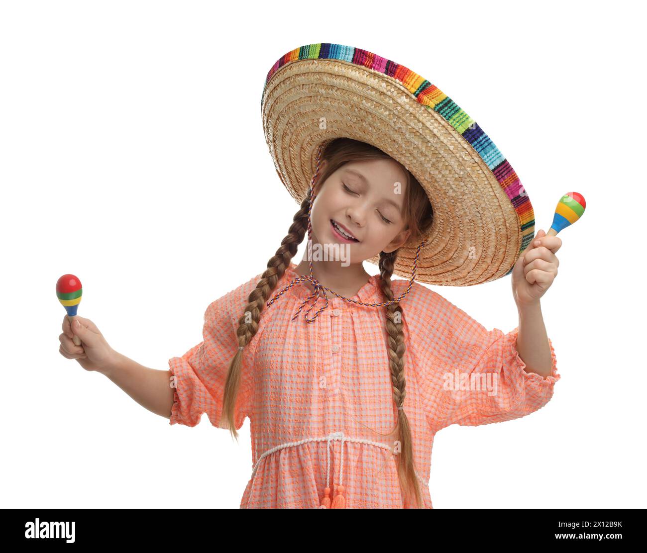 Cute girl in Mexican sombrero hat dancing with maracas on white ...