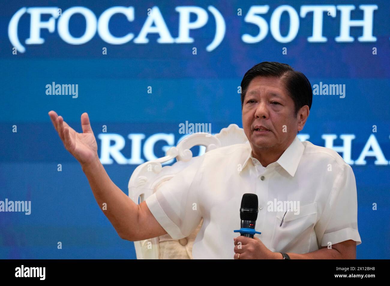 Philippine President Ferdinand Marcos Jr. gestures as he answers ...