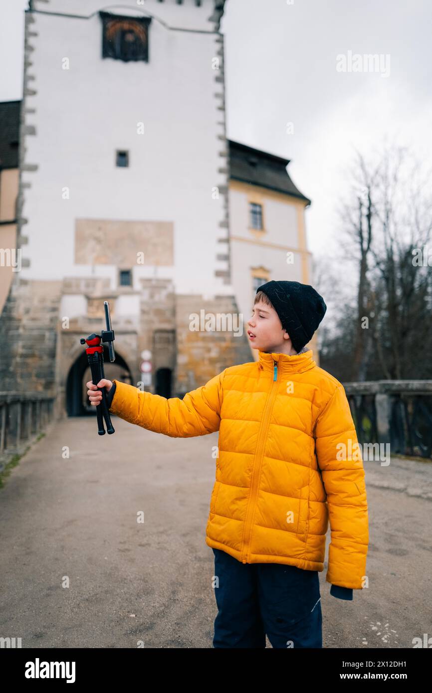A teenage boy streams a live video from Blatna Castle Stock Photo - Alamy
