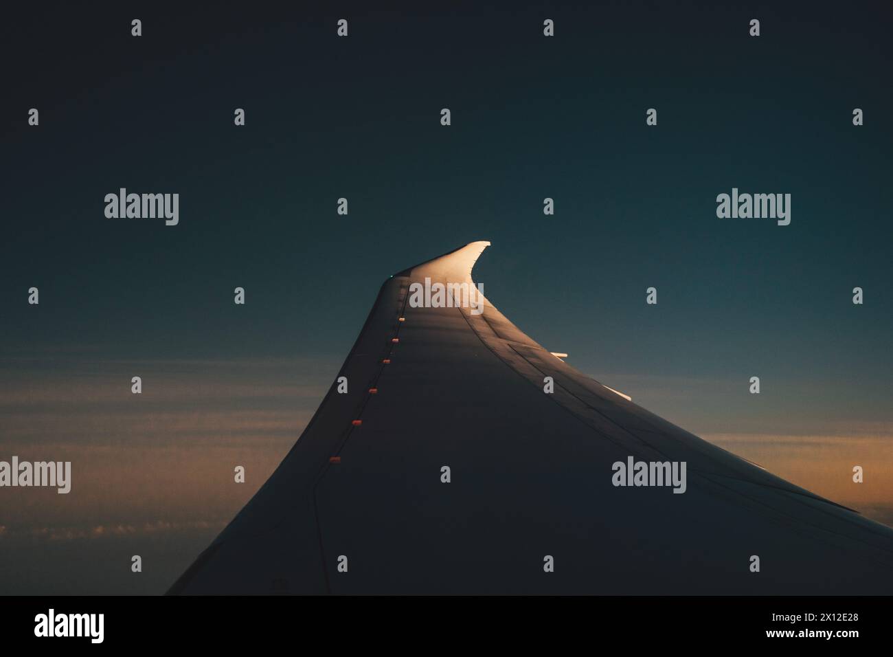 Airplane Wing in Dim Light at Blue Hour Stock Photo - Alamy