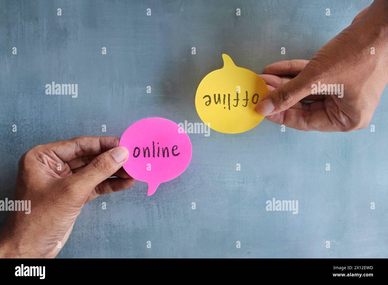 Top view image of hand holding speech bubble with text ONLINE and ...