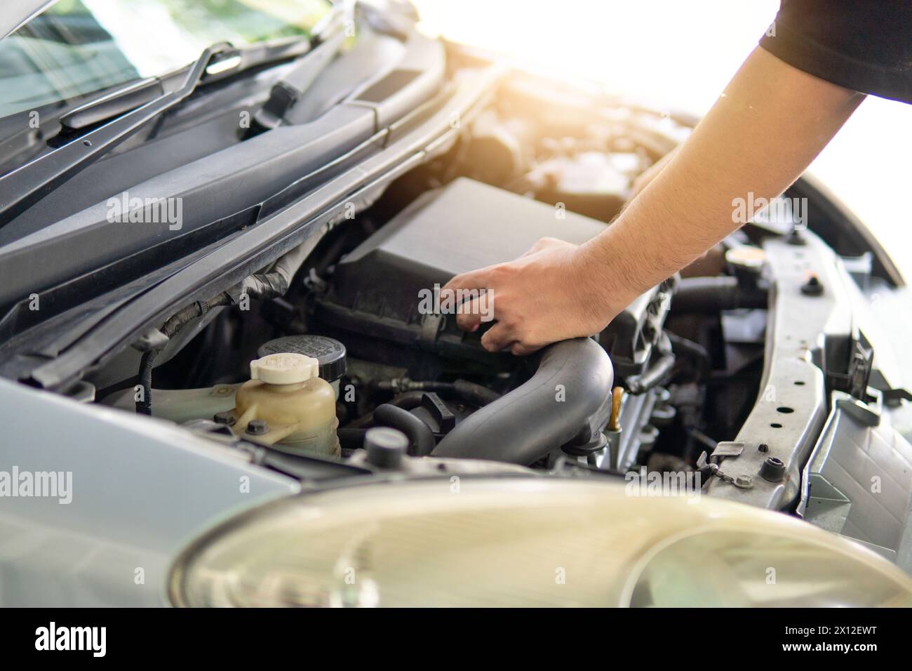 Close-up image of man inspecting and checking car engine ...