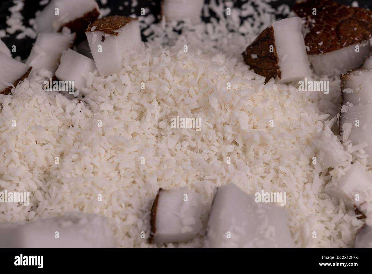 white coconut pulp and dried coconut flakes, a close-up of which is ...