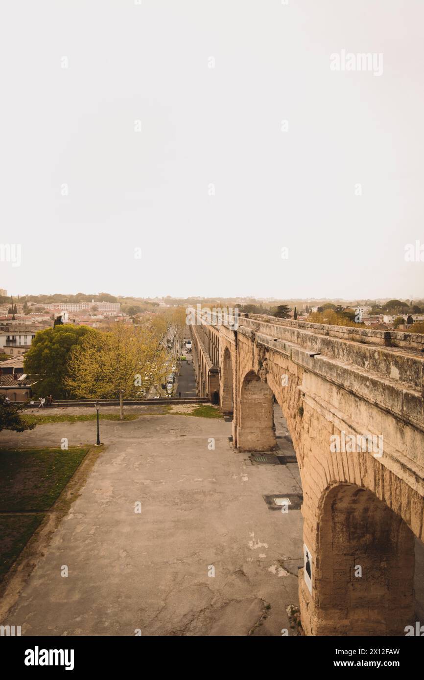 Old medieval aqueduct crossing the streets of Montpellier, France Stock ...