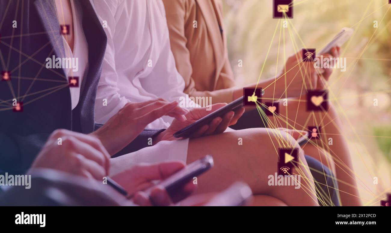 Image of media icons over diverse business people using smartphone ...