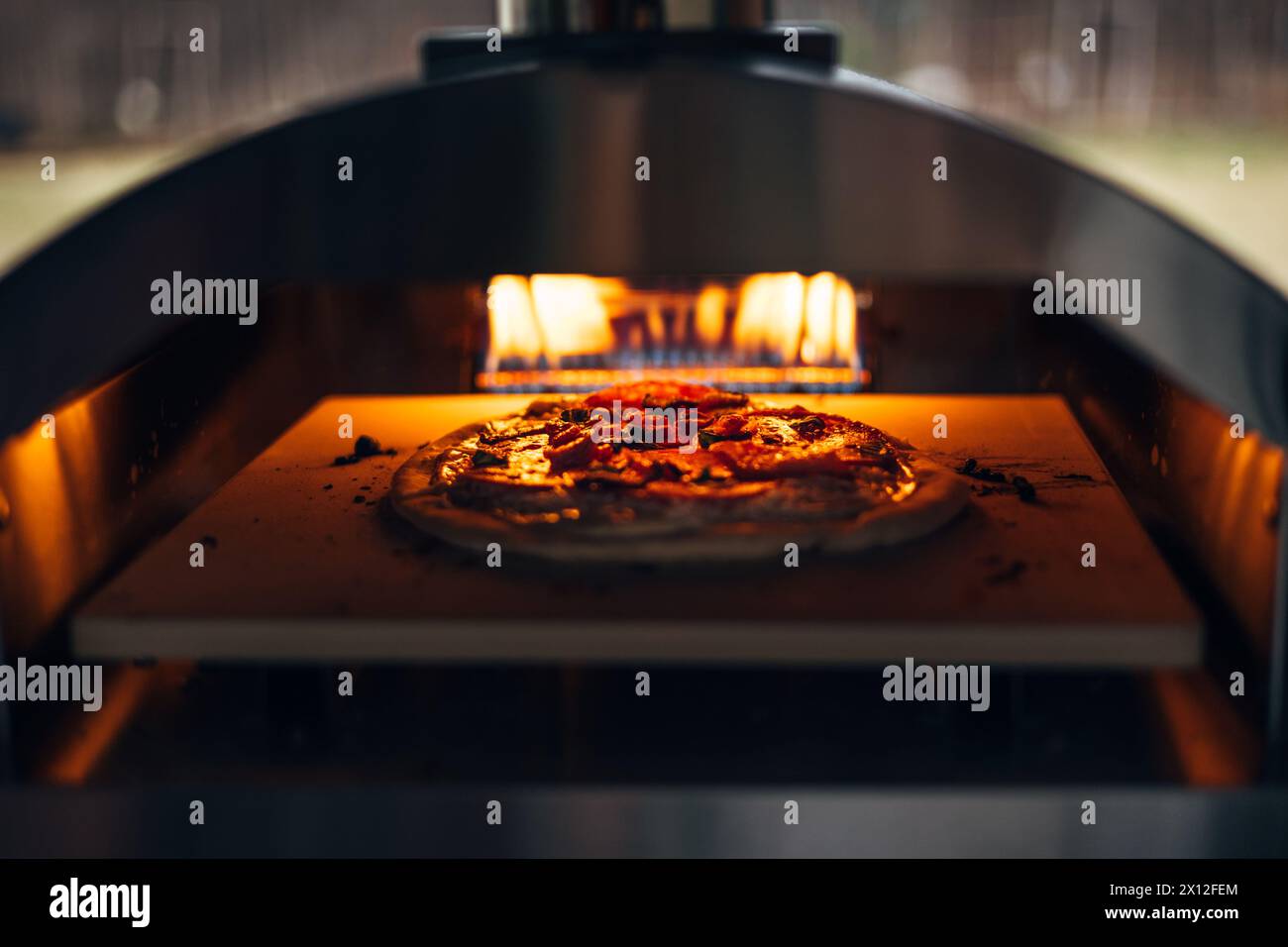 Pizza cooking in a pizza oven Stock Photo - Alamy