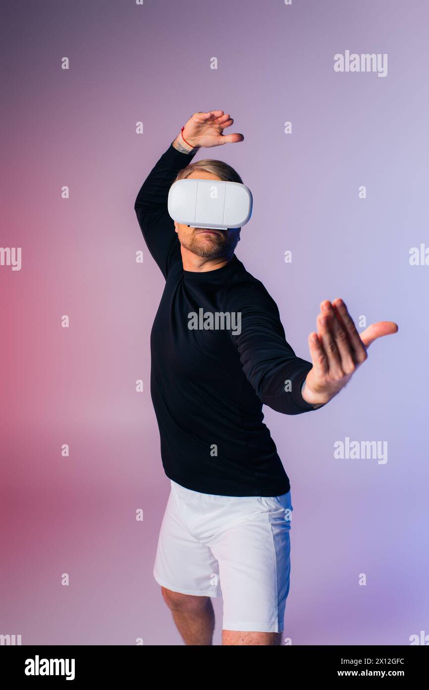 A man in a black shirt and white shorts is striking dynamic poses in a ...