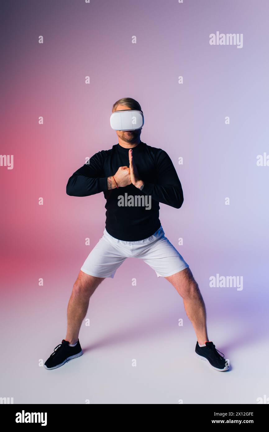A man wearing a vr stands in front of a pink and blue background, lost ...