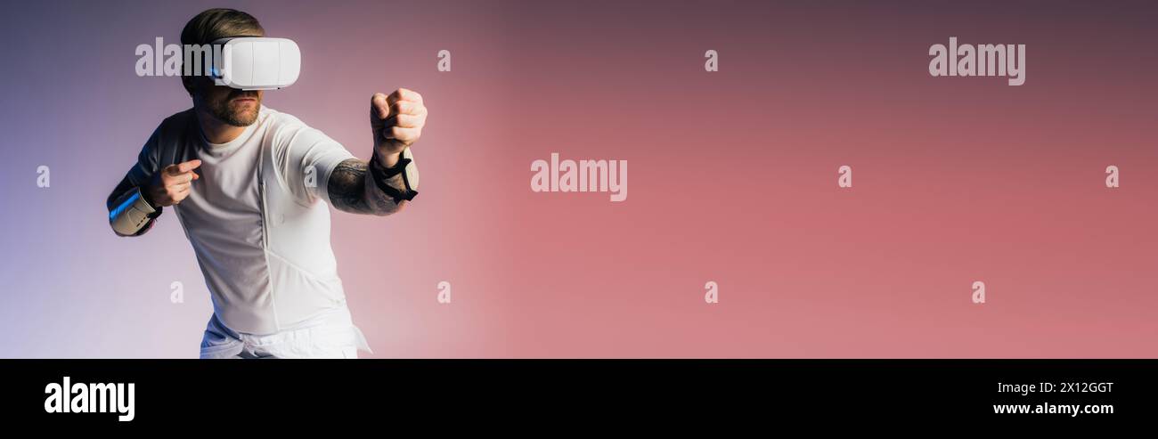 A man in a white t-shirt interacts with a virtual device, fully engaged ...