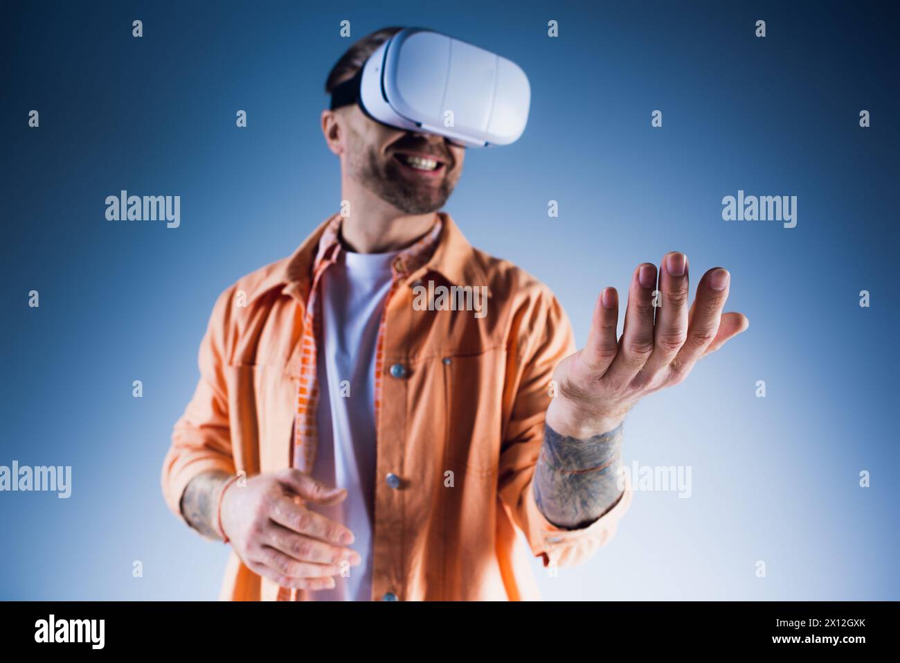 A man wearing a virtual headset while immersed in the metaverse in a studio setting Stock Photo ...