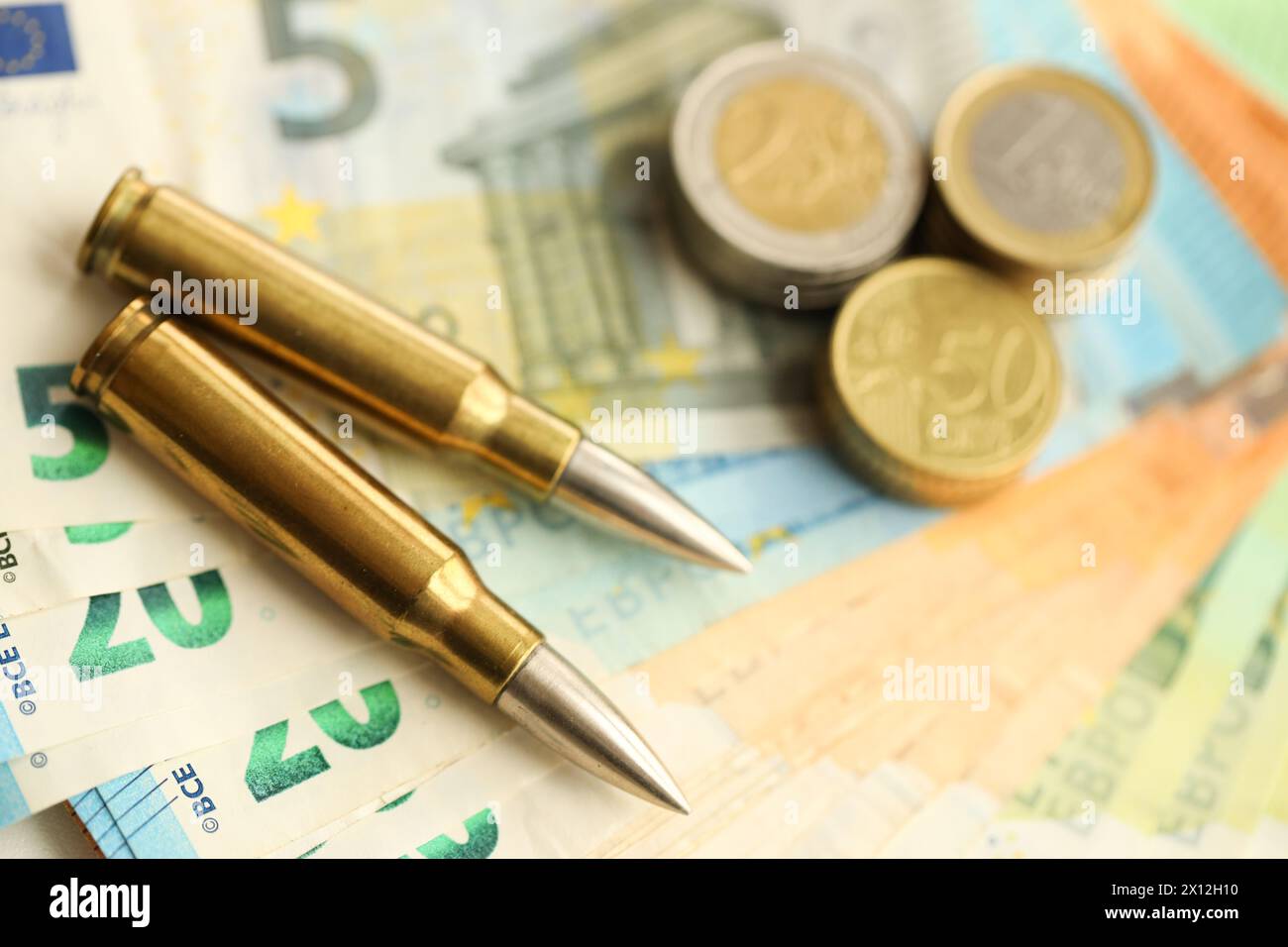 Yellow cartridges and shell casings on euro banknotes. Lot of bills of ...