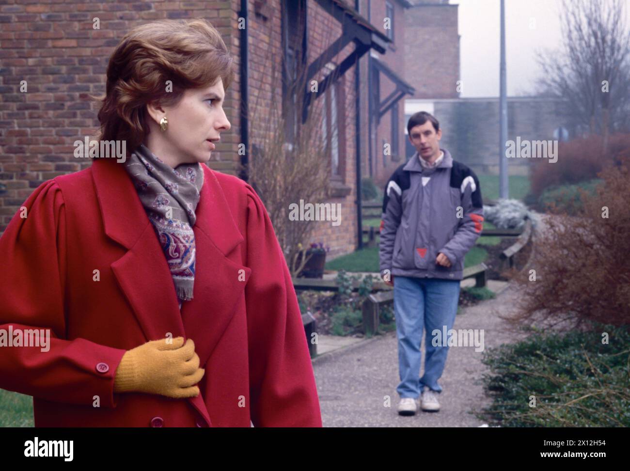 woman being followed and stalked by a man walking down a path Stock ...