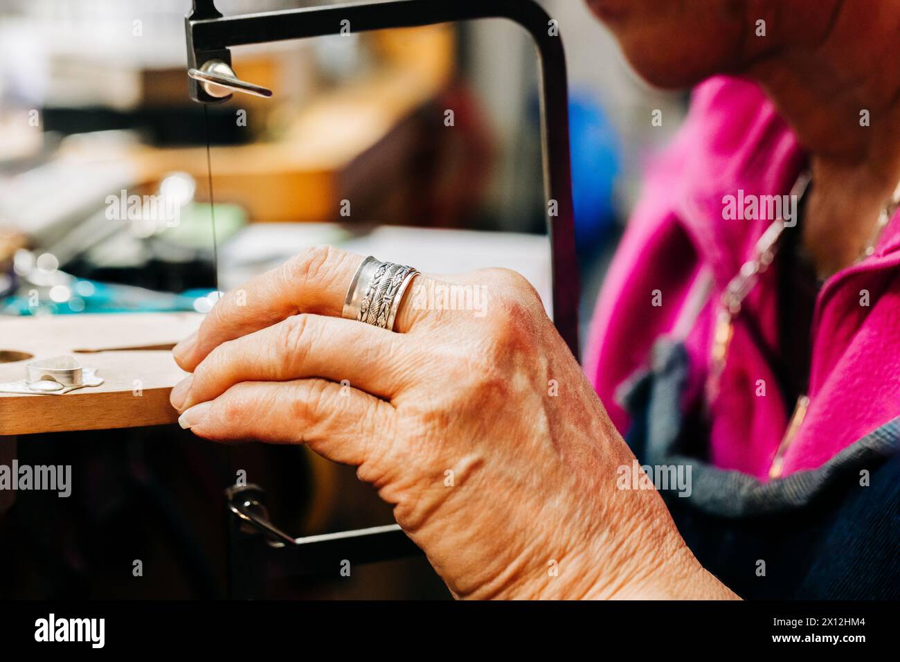 Close up of jeweler and hands using jewelers saw Stock Photo - Alamy