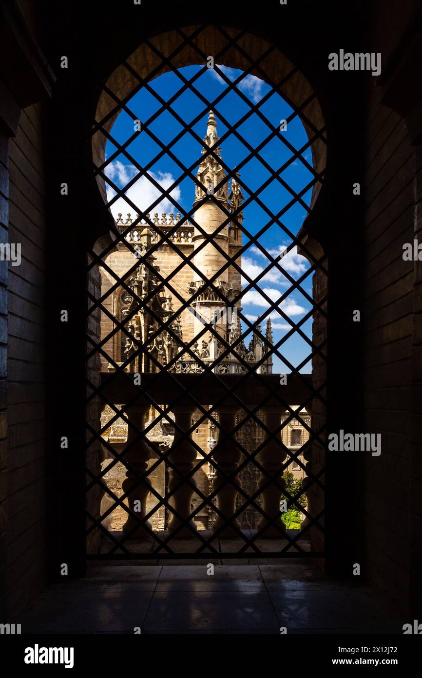 Seville,s Alcazar tower seen through an arabic style window Stock Photo ...