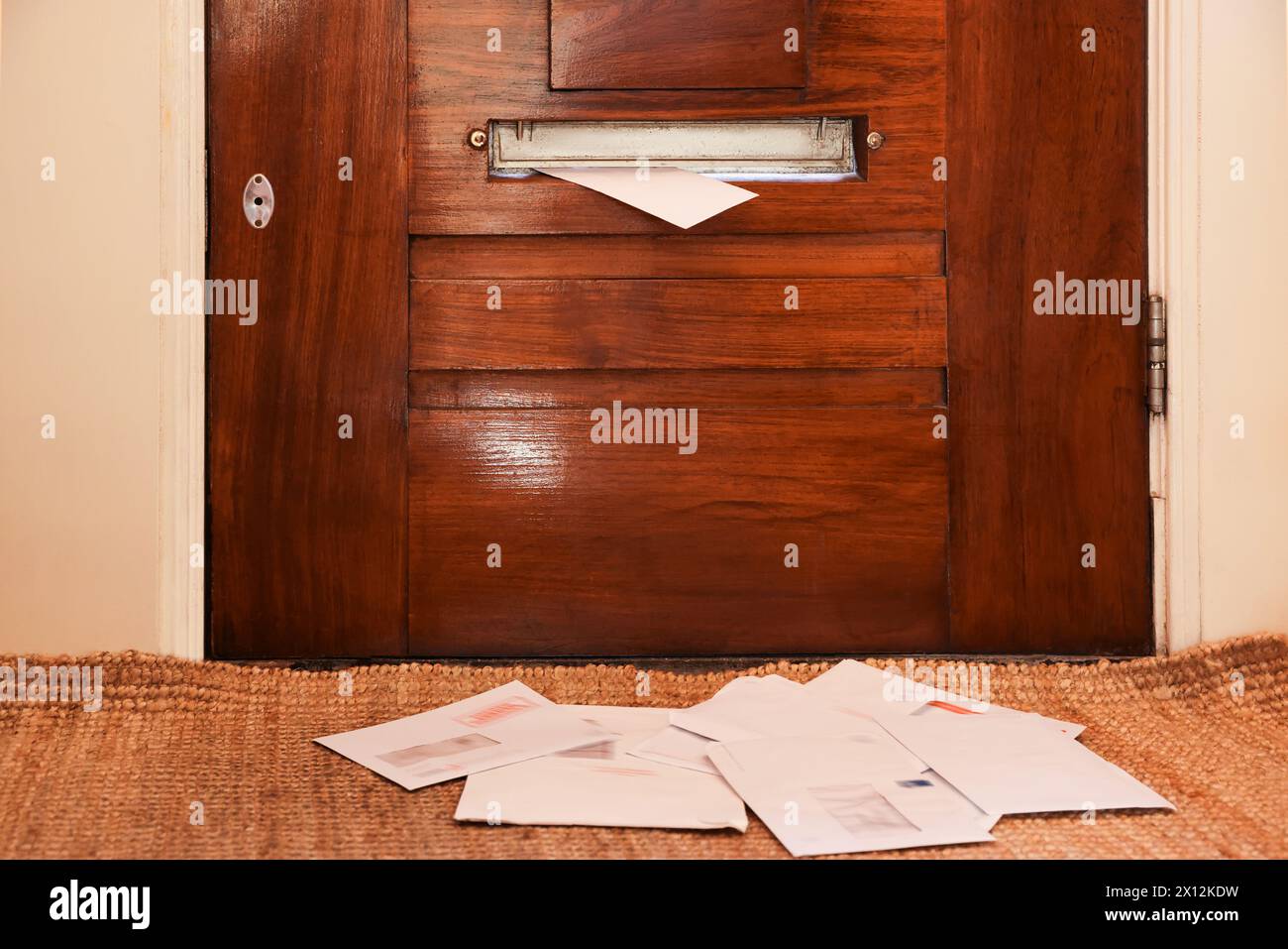 Wooden door with mail slot and many envelopes indoors Stock Photo - Alamy