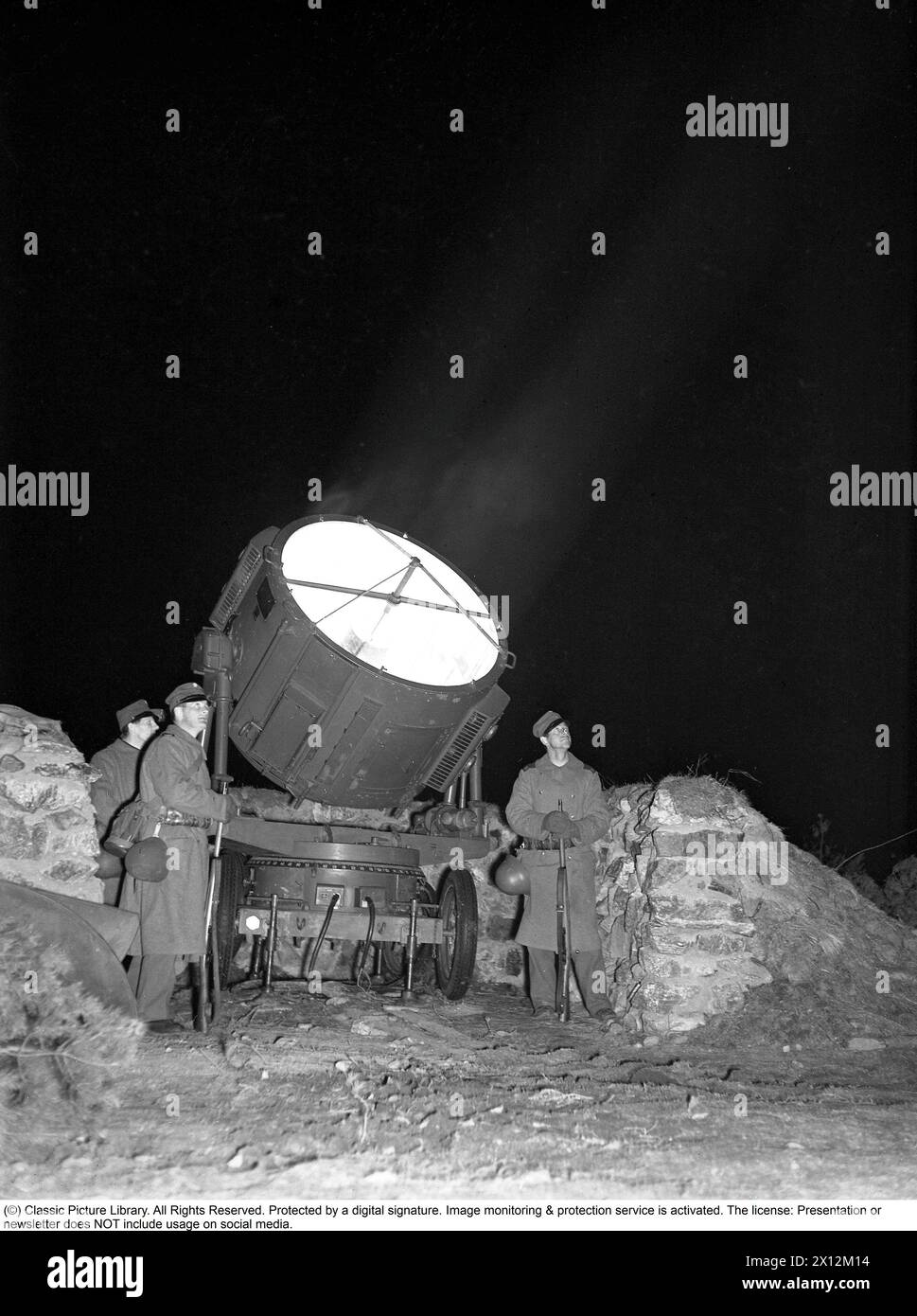 World War II. Swedish soldiers at a searchlight used to help the air ...