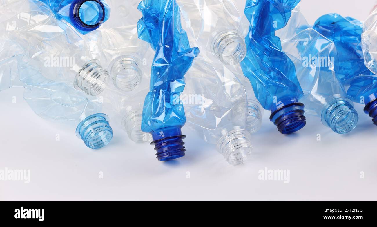 Crumpled disposable plastic bottles on white background Stock Photo - Alamy
