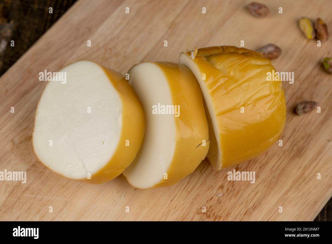 round processed cheese on the table, sausage cheese made from cow's ...