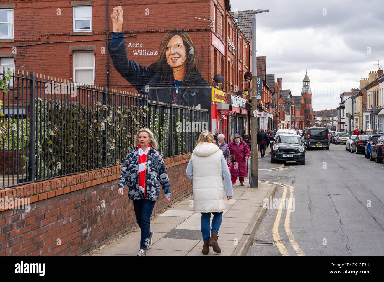 Football fans on match day in Anfield, Liverpool, walking beneath the ...