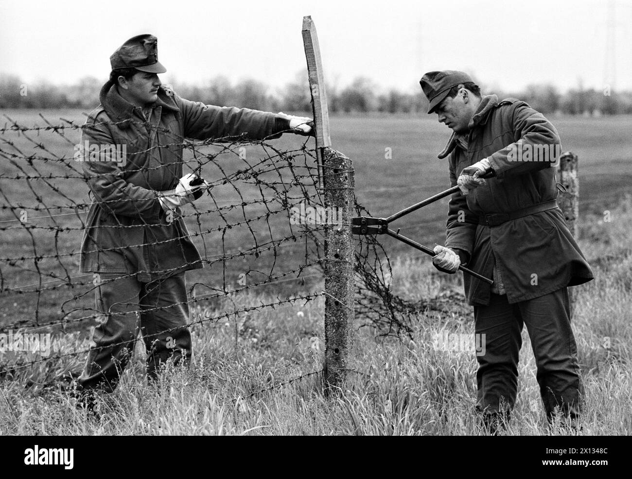 Hungarian soldiers destroy the Iron Curtain between Austria and Hungary ...