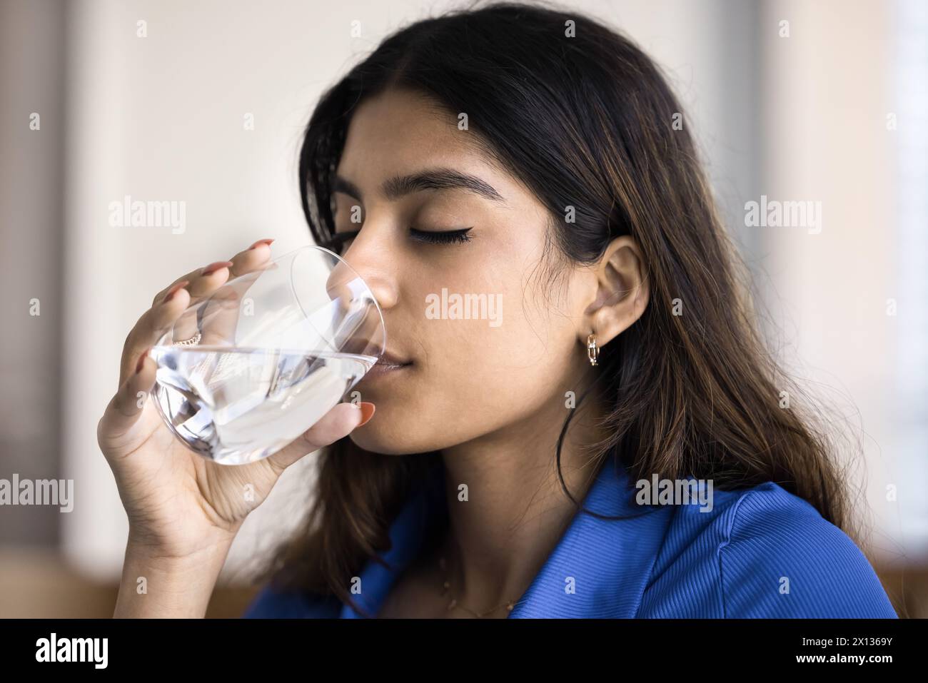 Beautiful Indian girl with closed eyes enjoying fresh pure water Stock Photo - Alamy