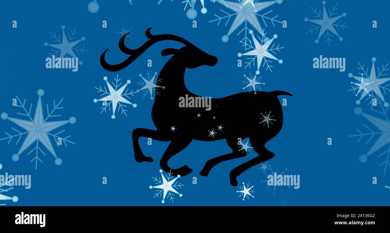Image of reindeer over snow falling on blue background Stock Photo - Alamy