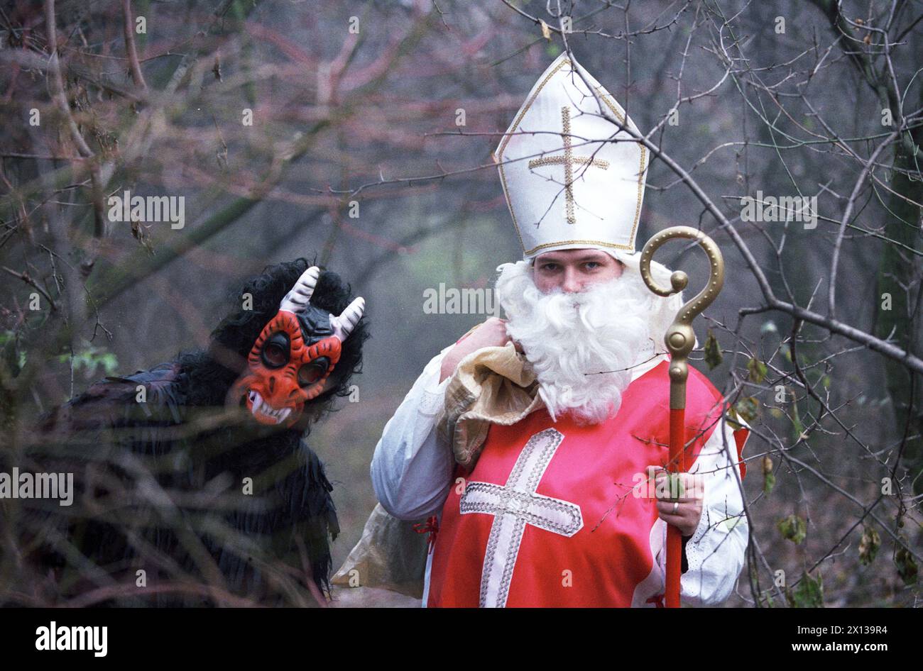 Nikolaus (Santa Claus) and his servant Krampus on their way to good and ...