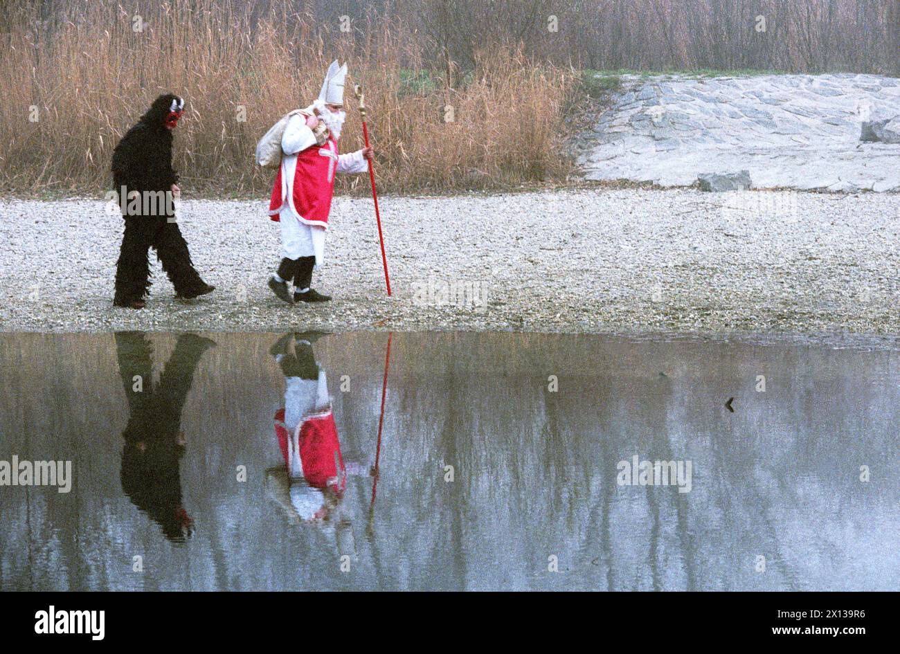 Nikolaus (Santa Claus) and his servant Krampus on their way to good and ...