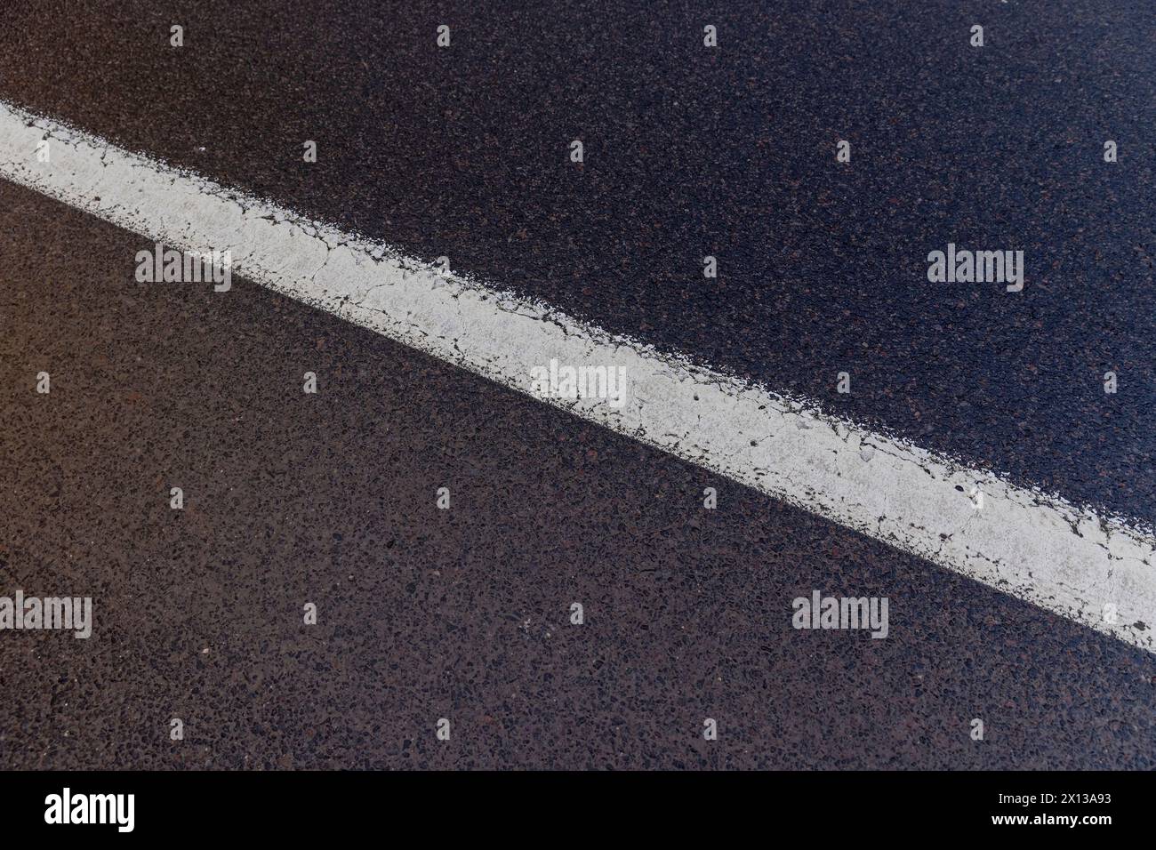 old road markings on the highway in winter, old paved road with white ...