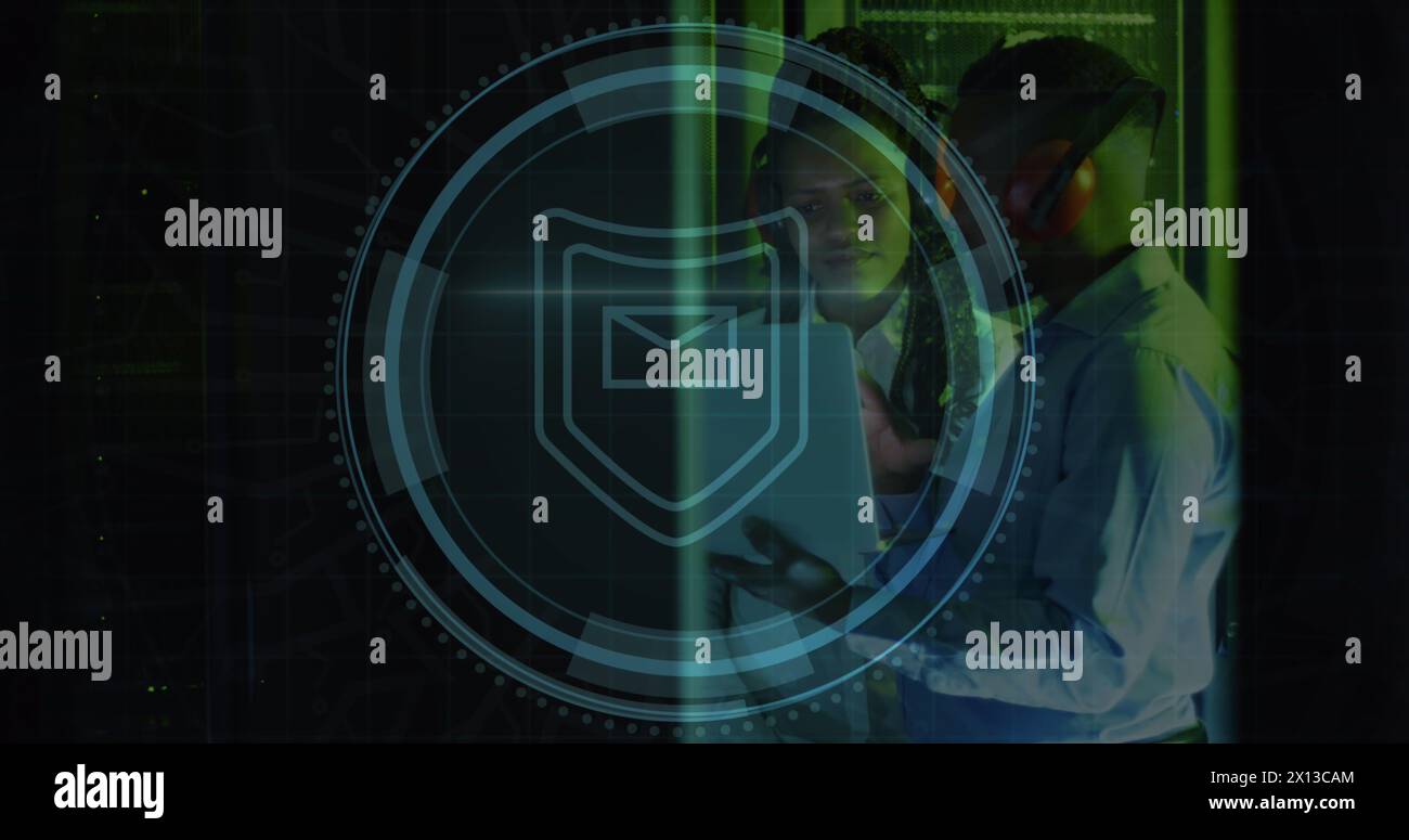 Image of shield icon over african american male and female engineer using laptop at server room ...
