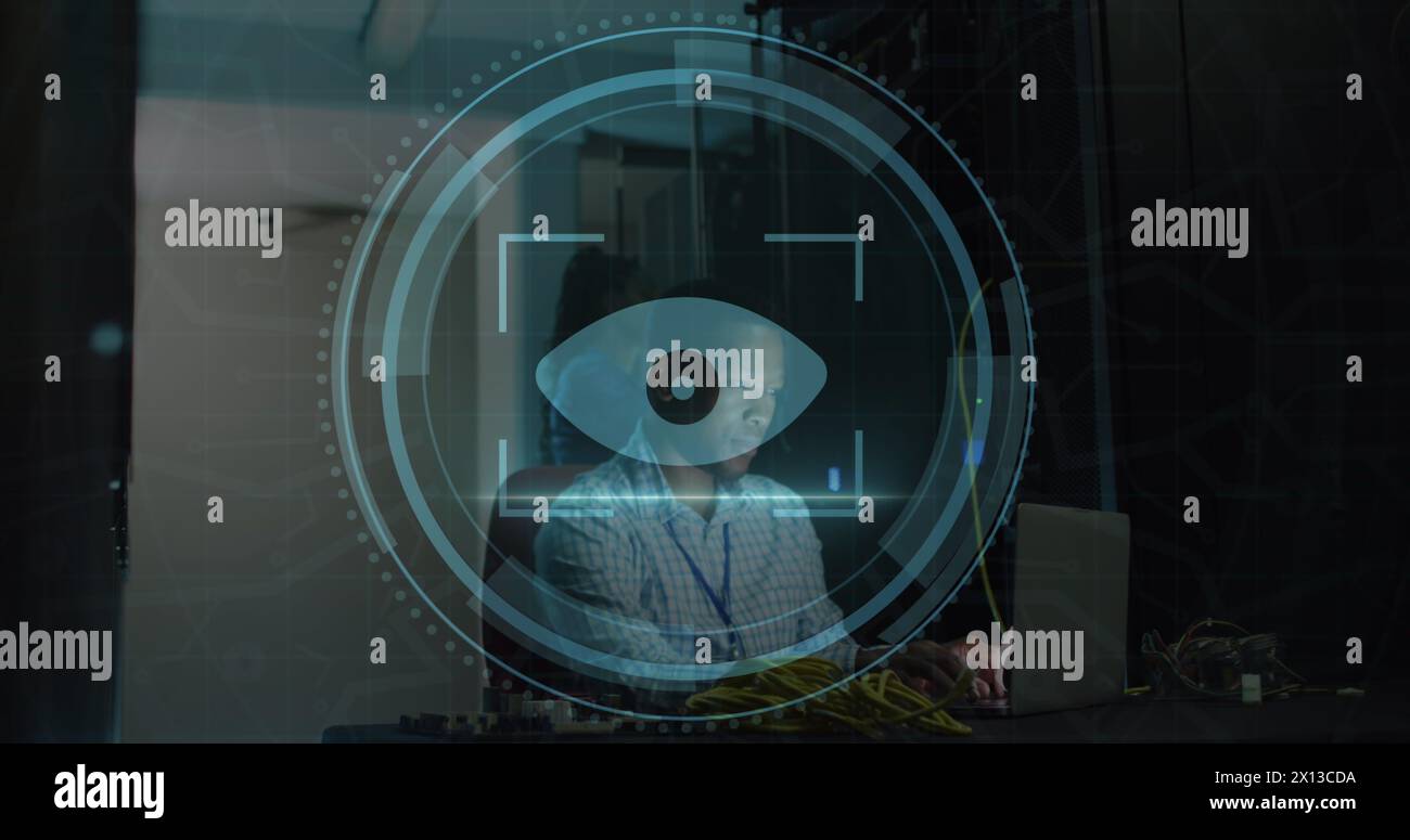Image of eye retina scanner over african american male engineer using laptop at server room ...