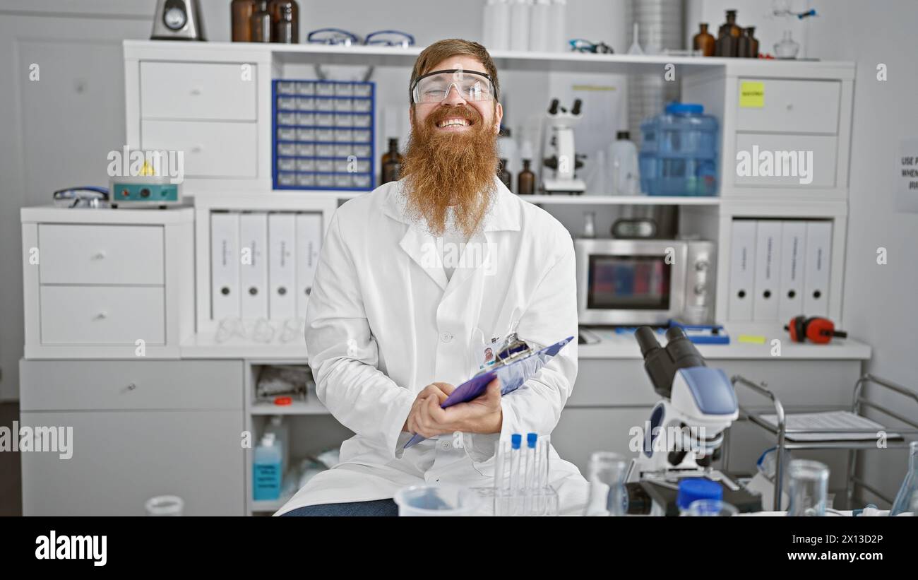 Handsome redhead male scientist working with a smile, young man ...