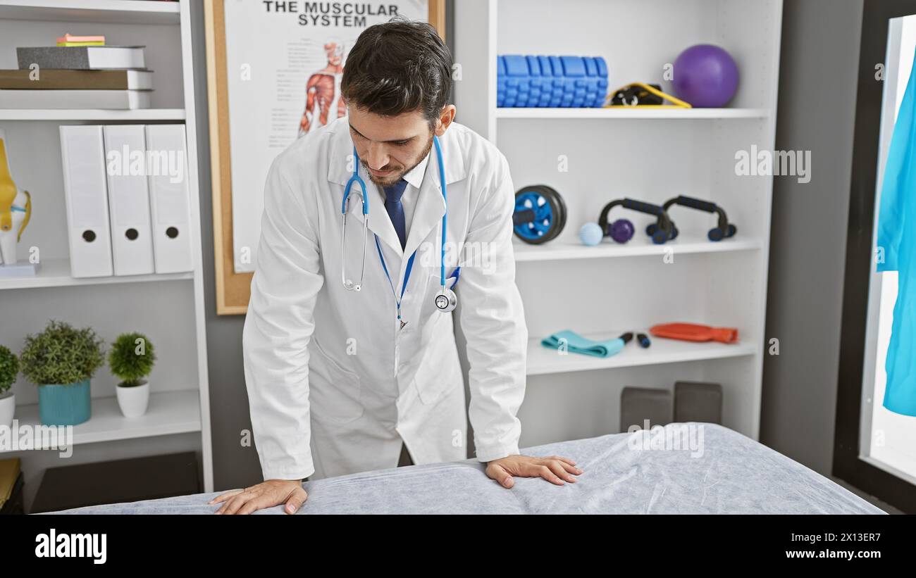 Hispanic man in white lab coat standing in a clinic rehabilitation room ...