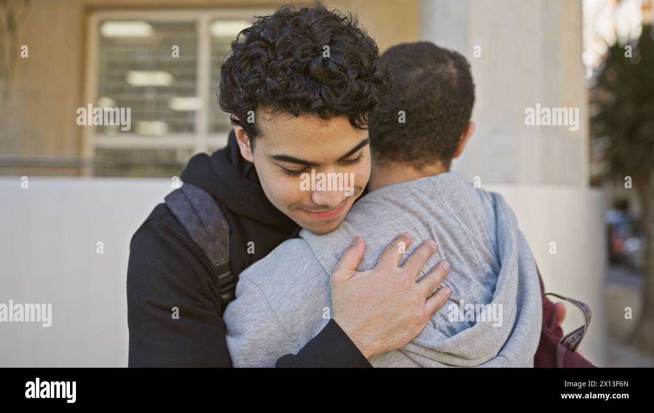 Two men embracing each other affectionately on an urban street ...