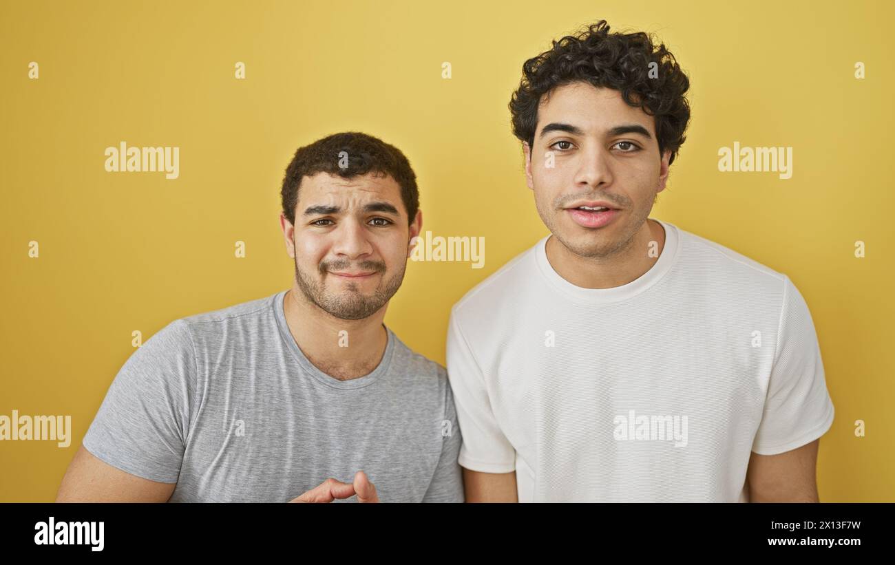 Two hispanic men standing closely, expressing friendship against a ...