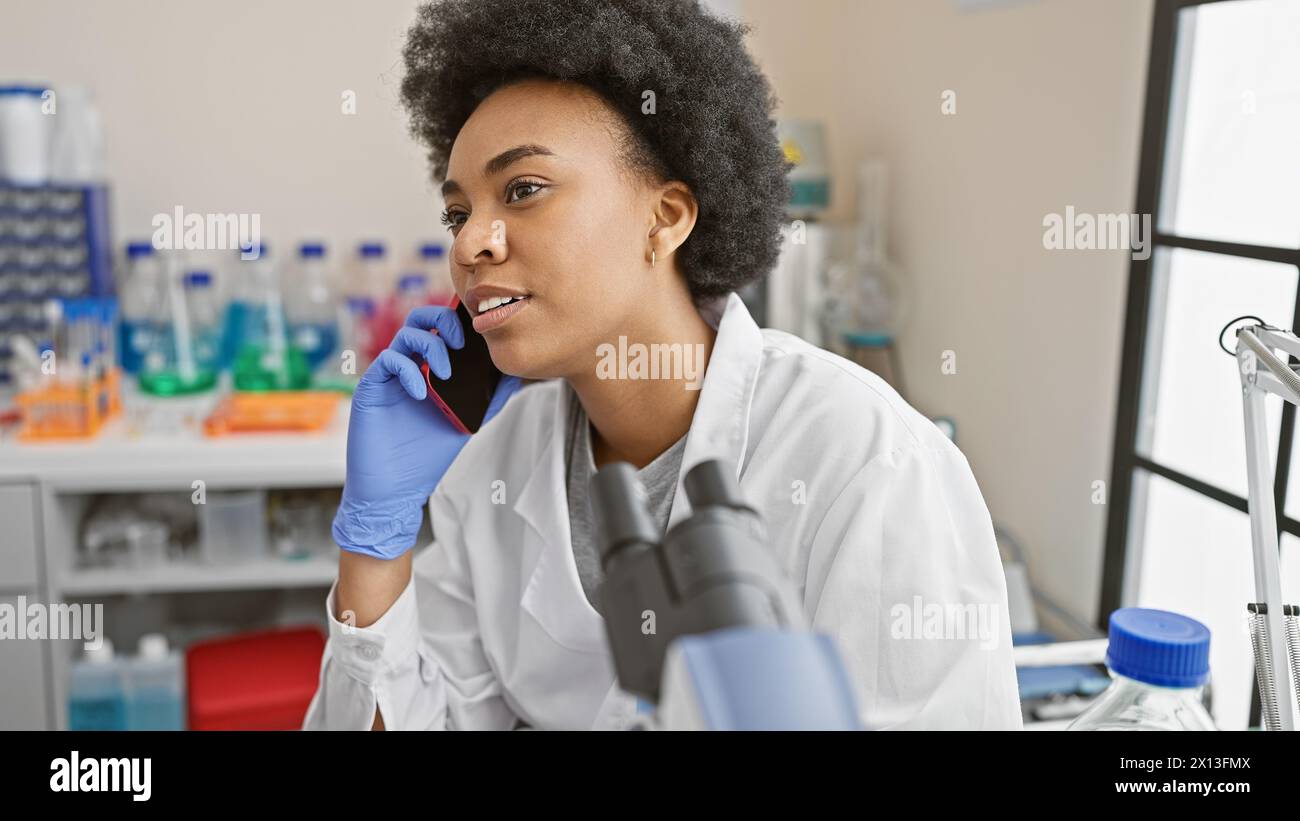 African american female scientist working in a well-equipped laboratory ...