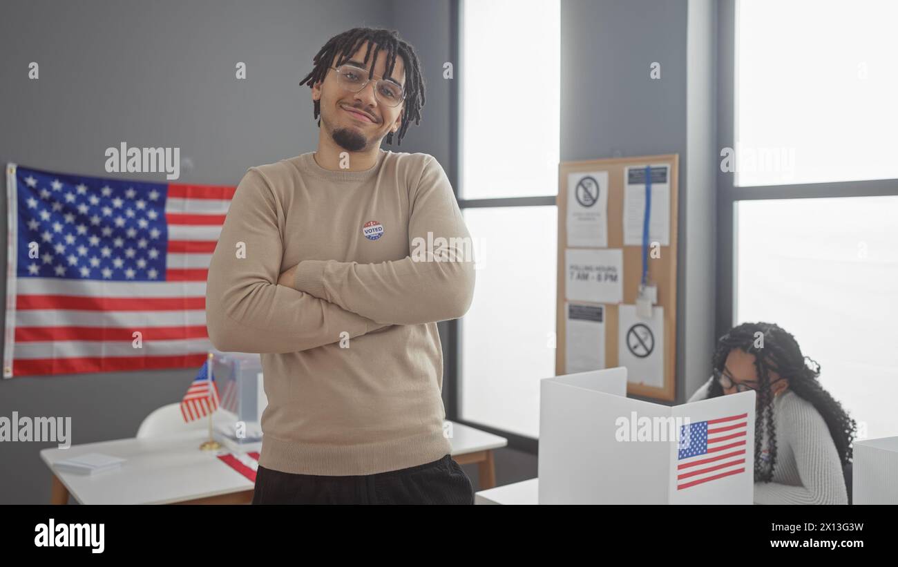 A proud man with a 'i voted' sticker stands arms crossed in a us ...