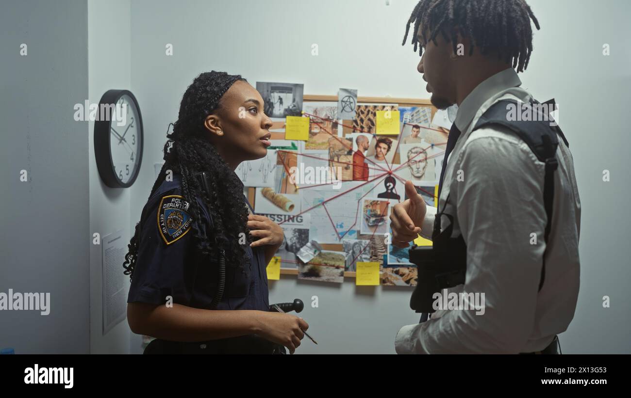 A policewoman and investigator discuss a case in an office with a ...